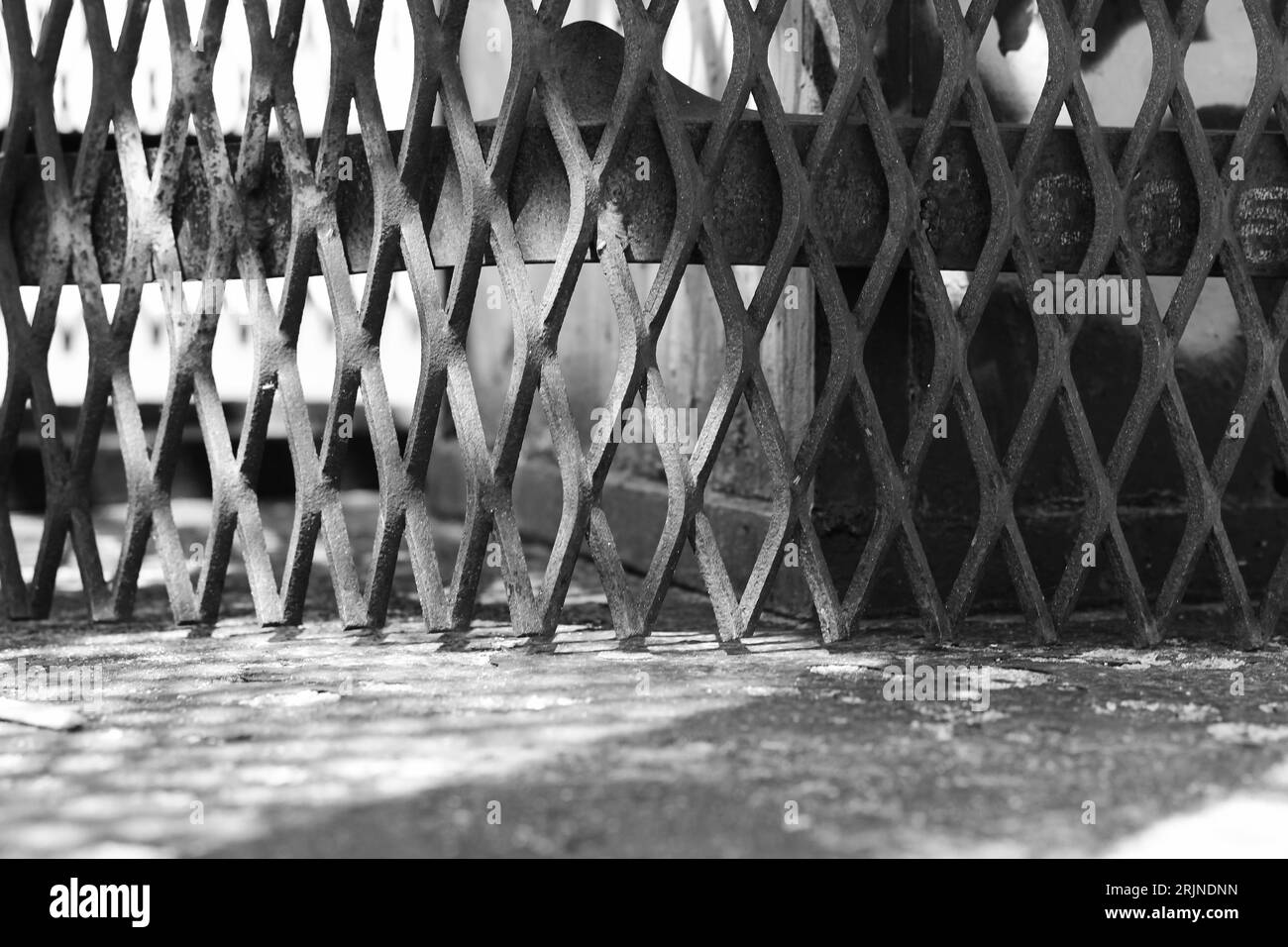 A common industrial chain link metal fence with a repeating pattern in ...