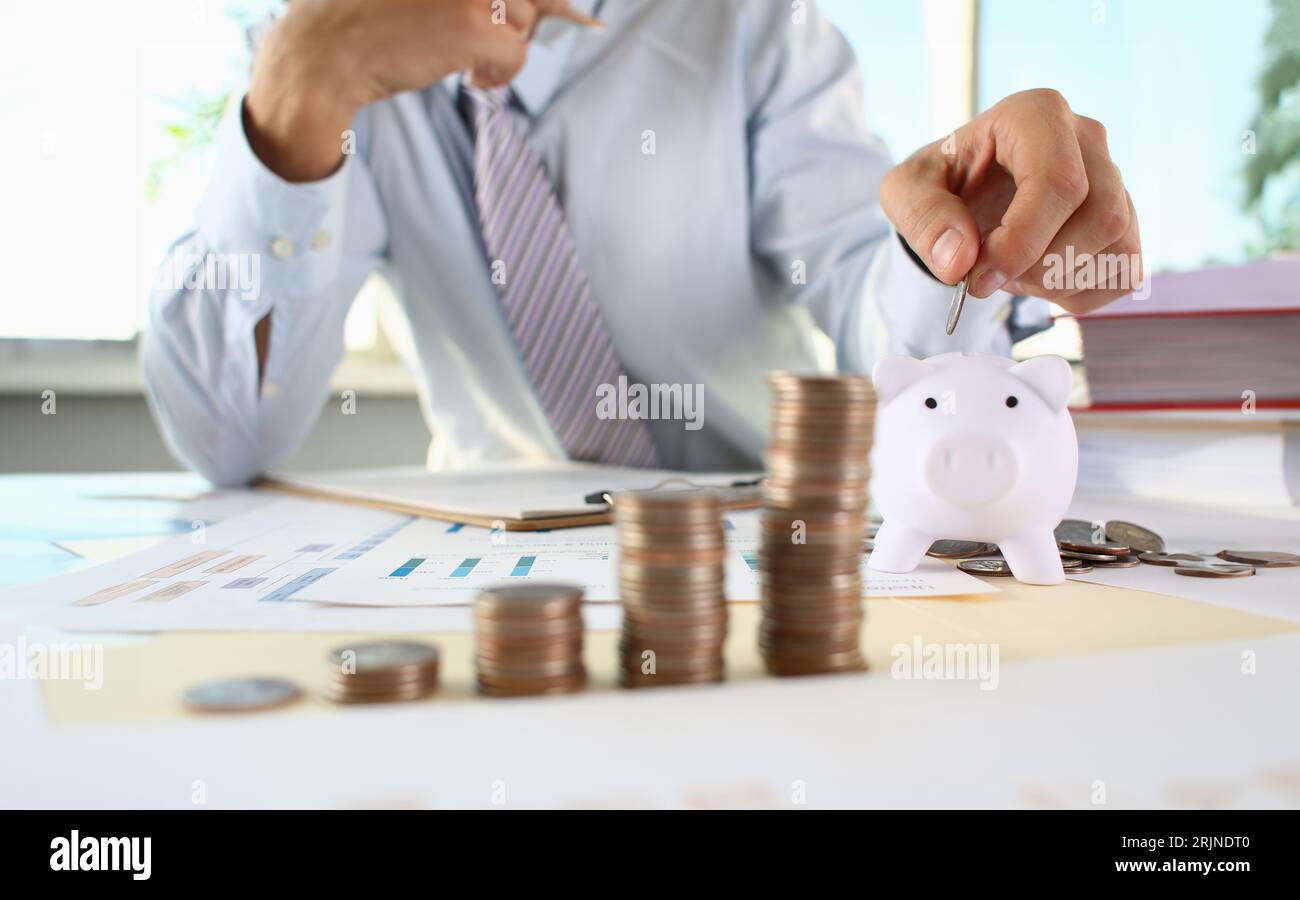 Hand businessman putting pin money Stock Photo - Alamy