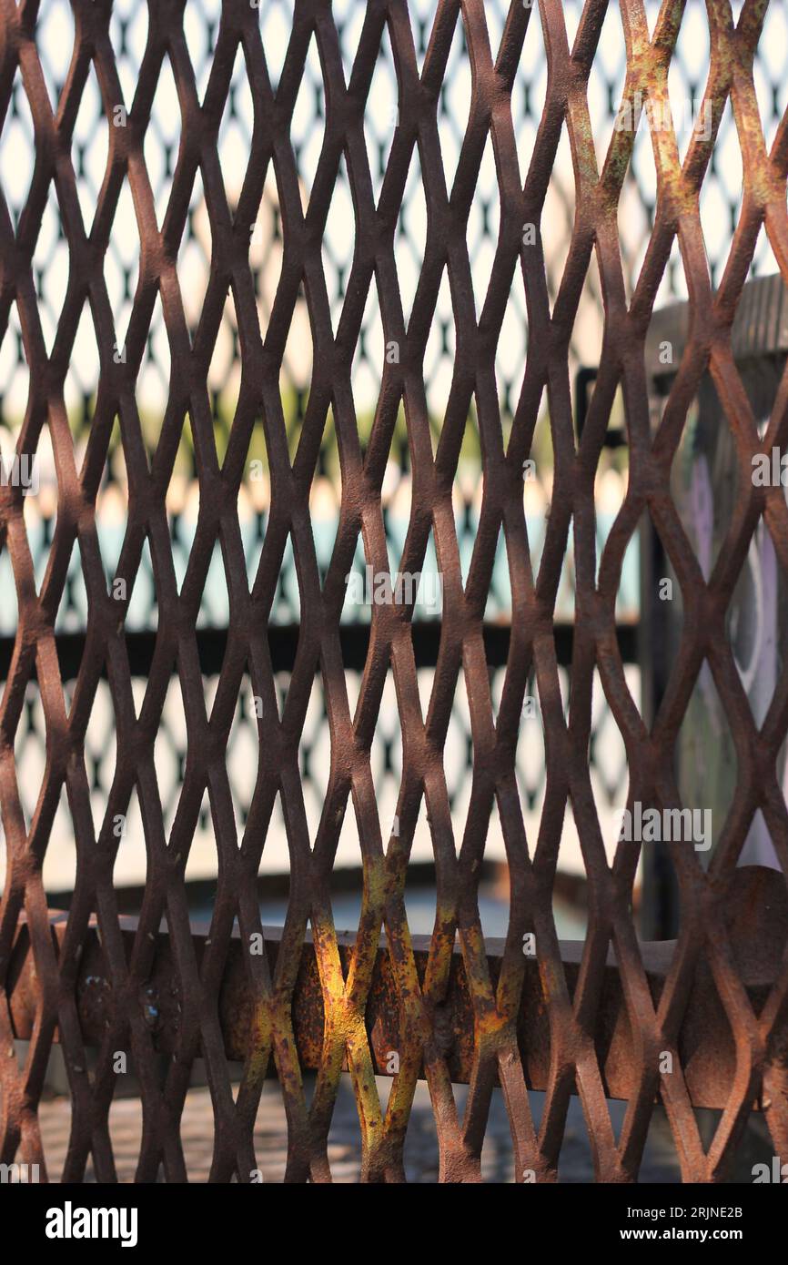 A common industrial chain link metal fence with a repeating pattern ...