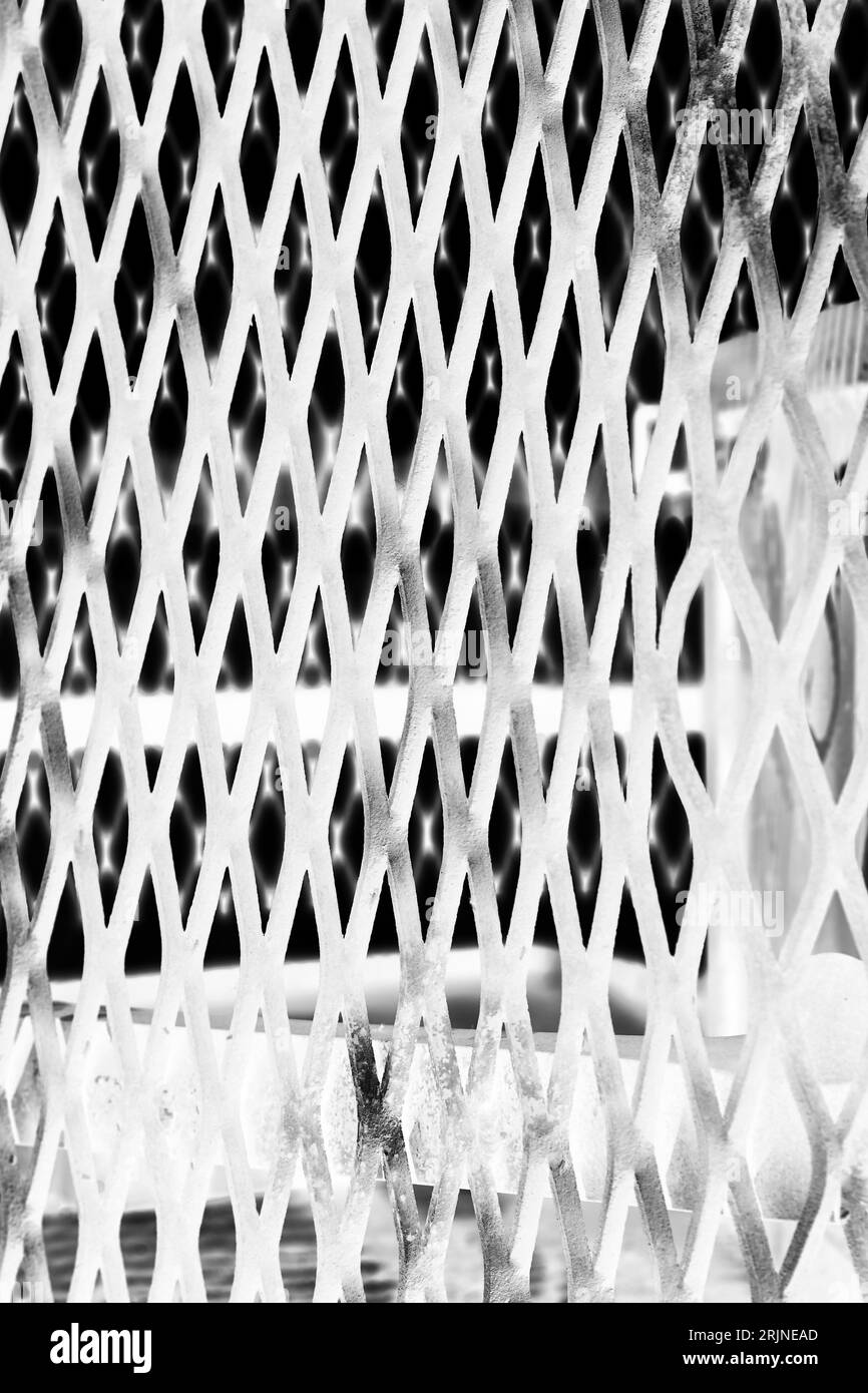 A common industrial chain link metal fence with a repeating pattern in ...