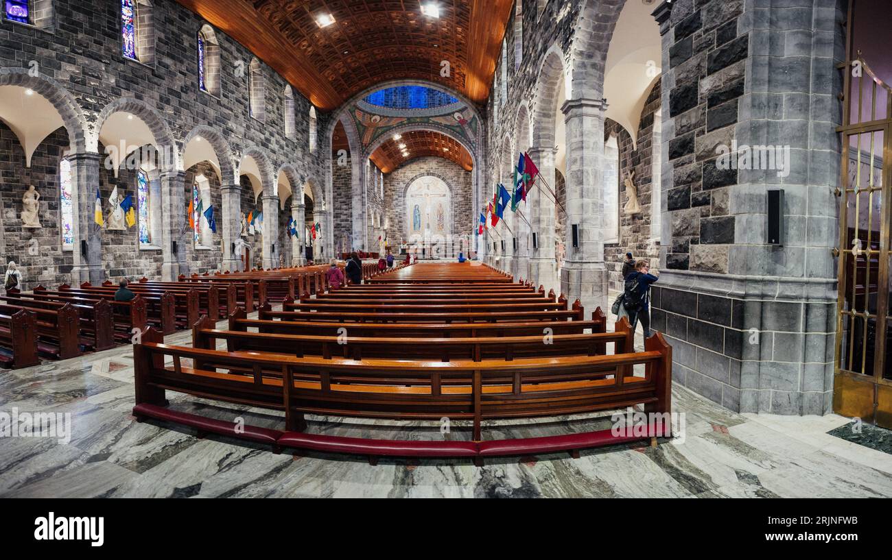 An interior view of a classic church featuring a large window with a ...