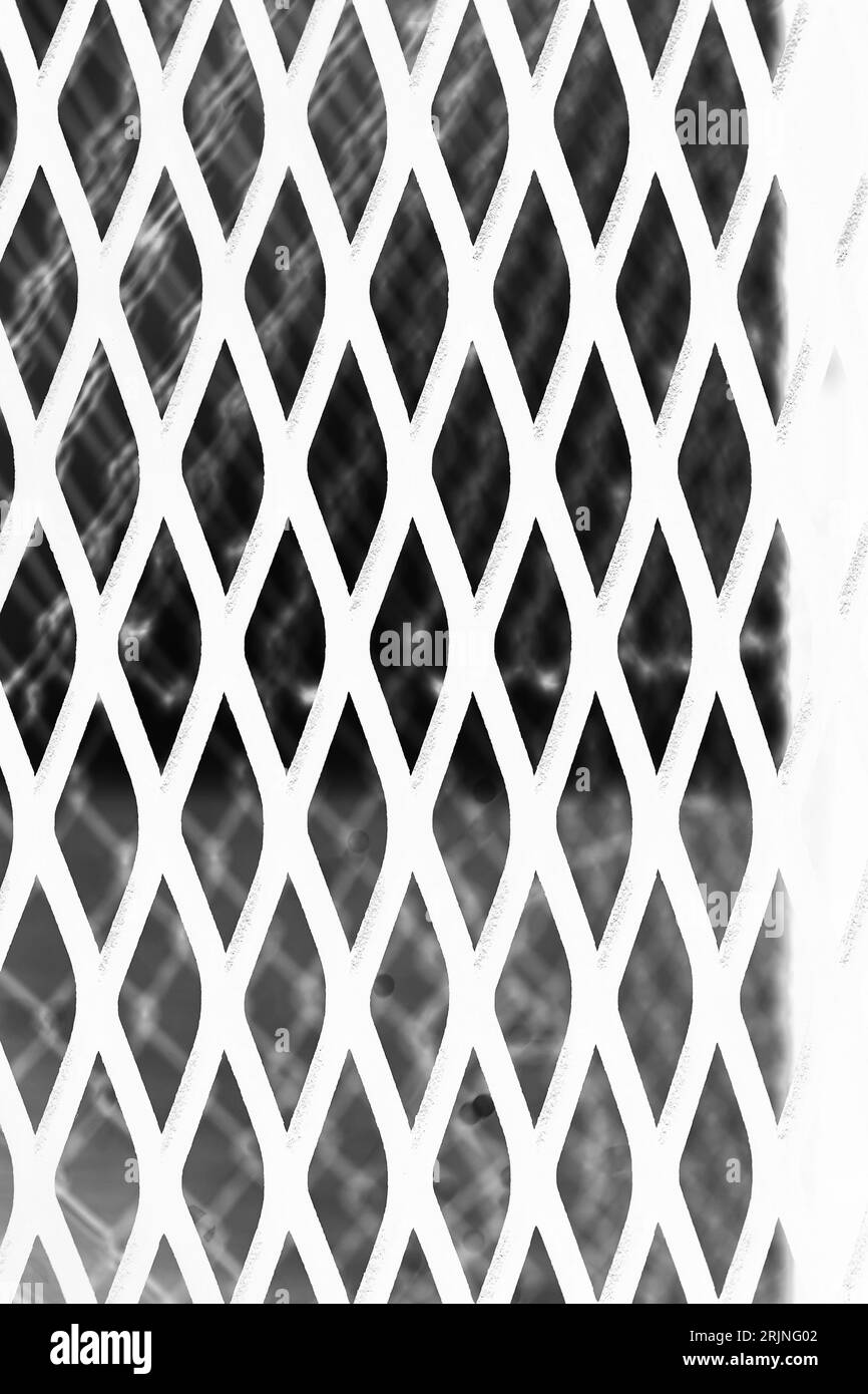 A common industrial chain link metal fence with a repeating pattern in ...