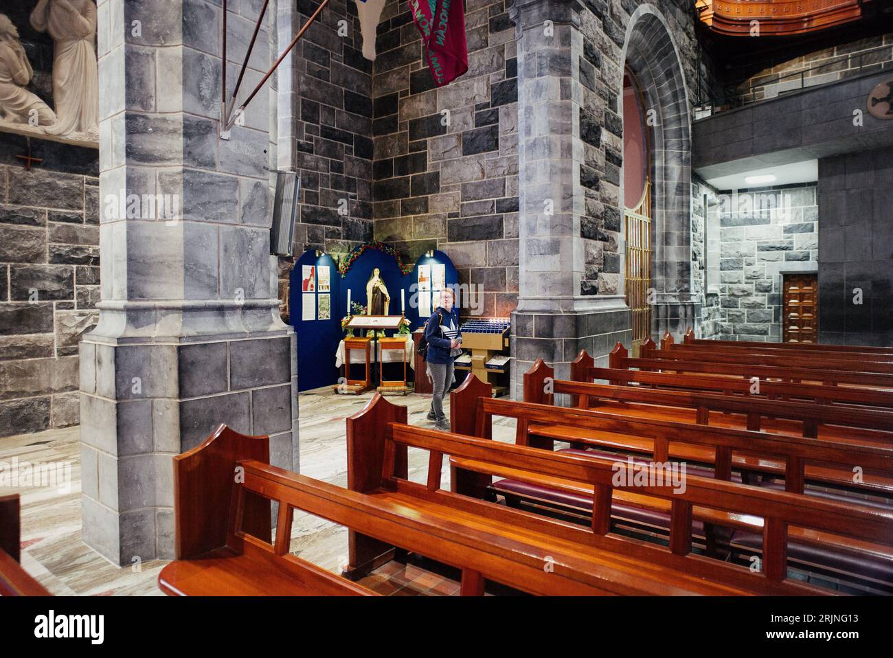 An interior view of a church, with rows of wooden benches Stock Photo ...