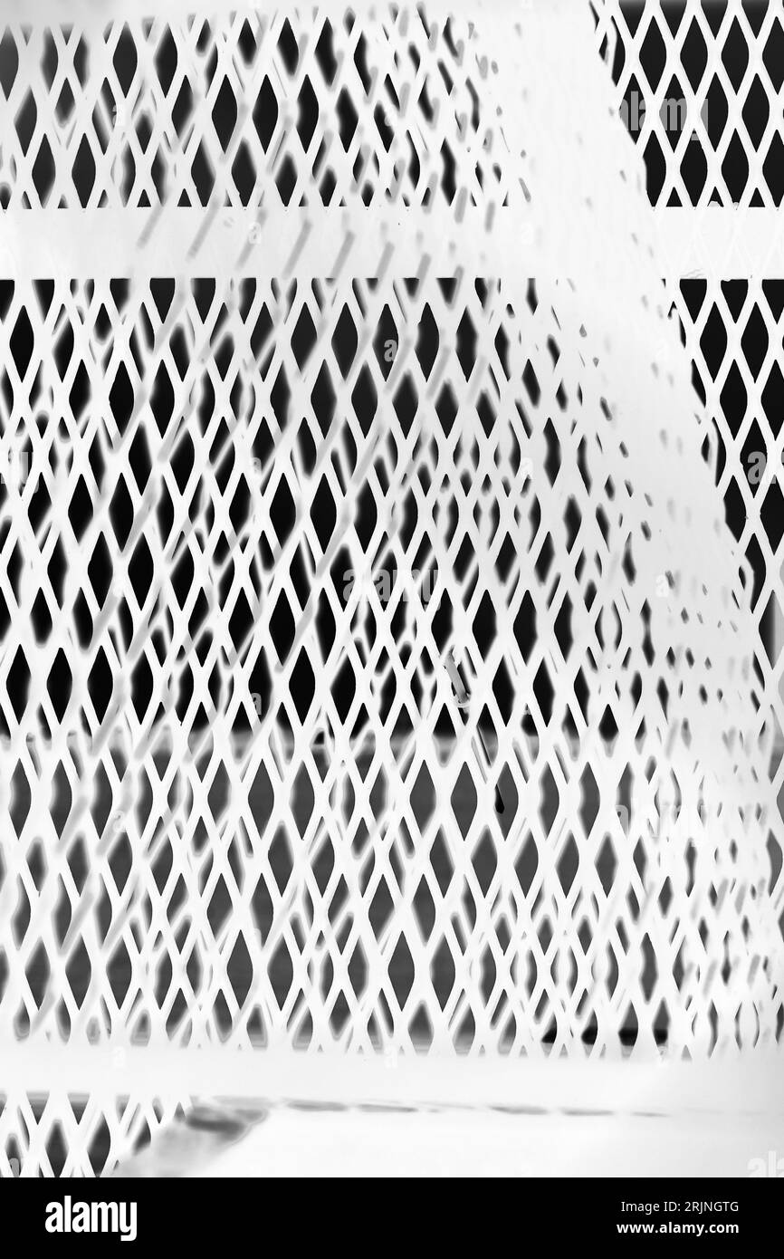 A common industrial chain link metal fence with a repeating pattern in ...