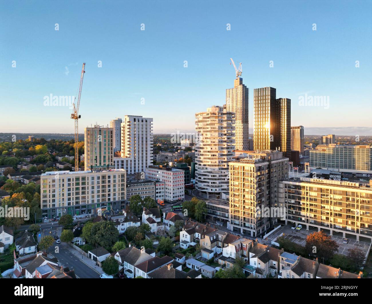 An aerial view of a cityscape featuring a towering skyscraper under the ...