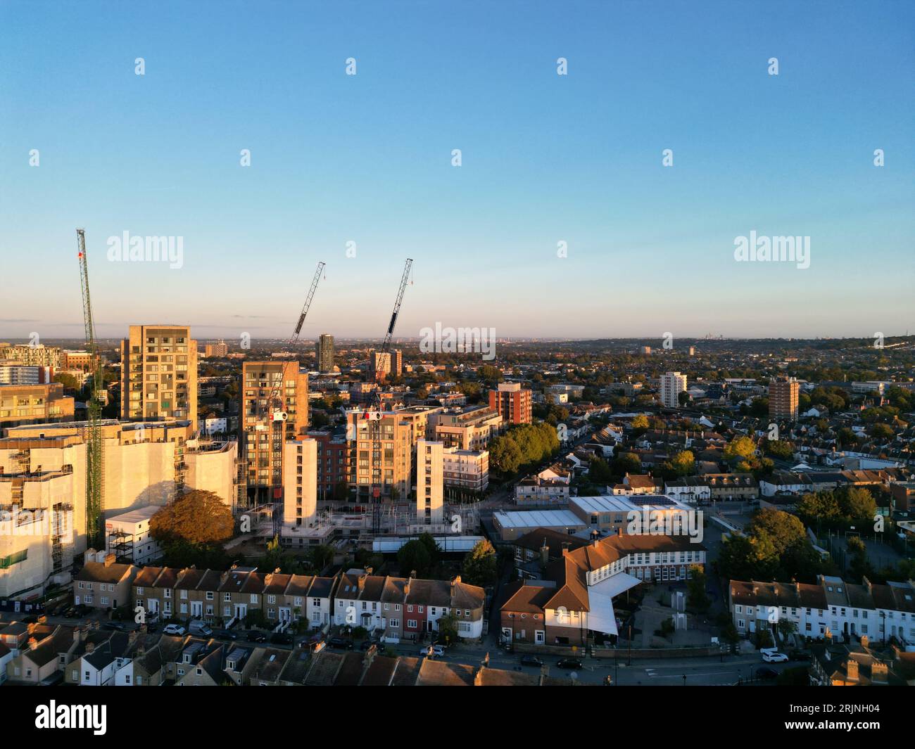 An aerial view of a cityscape featuring a towering skyscraper under the ...