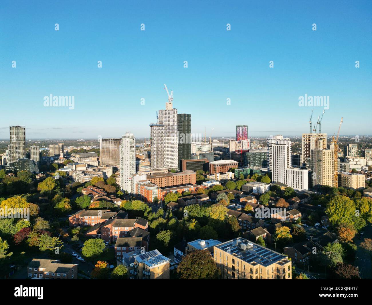 An aerial view of a cityscape featuring a towering skyscraper under the ...