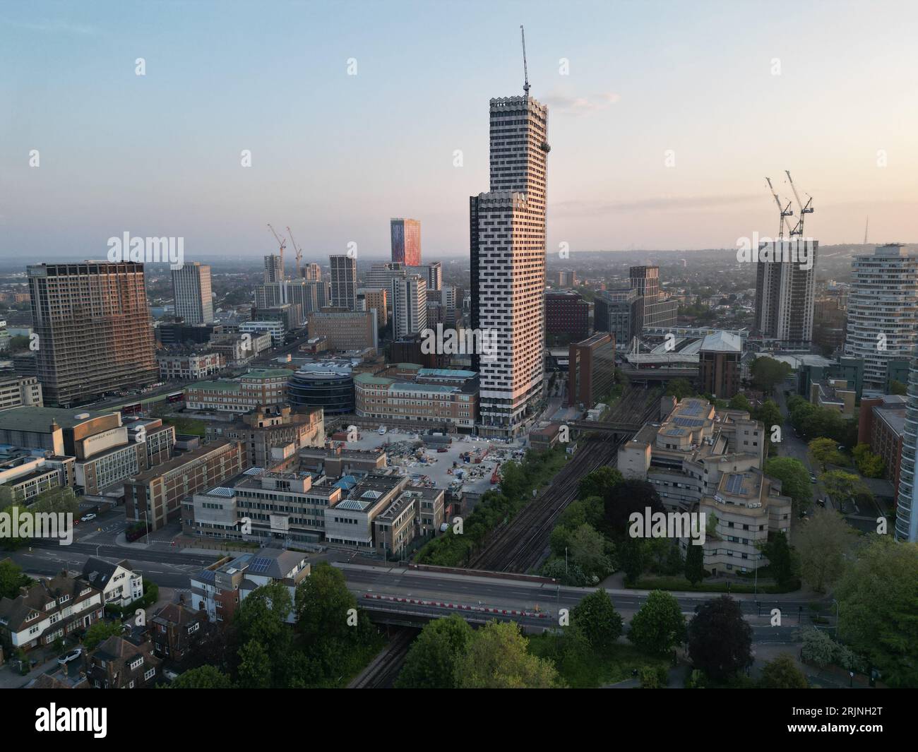 An aerial view of a cityscape featuring a towering skyscraper under the ...
