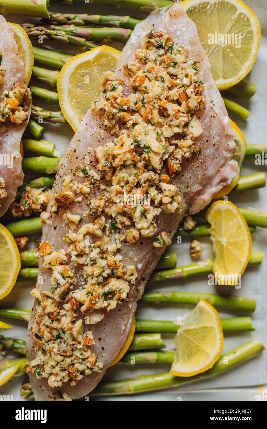 Raw pacific rockfish on a bed of asparagus, lemon wheels with brown ...