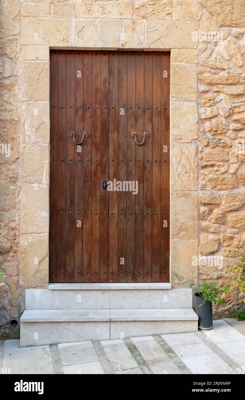 A traditional, wooden entrance door with a detailed stone frame Stock ...