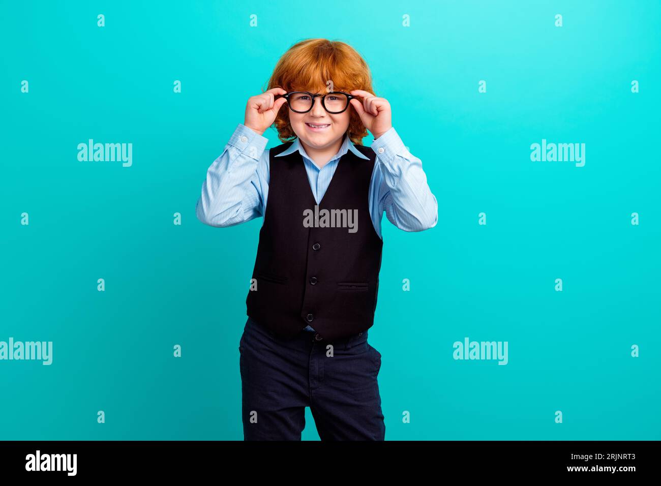 Portrait of cheerful smart small schoolkid toothy smile hands touch ...