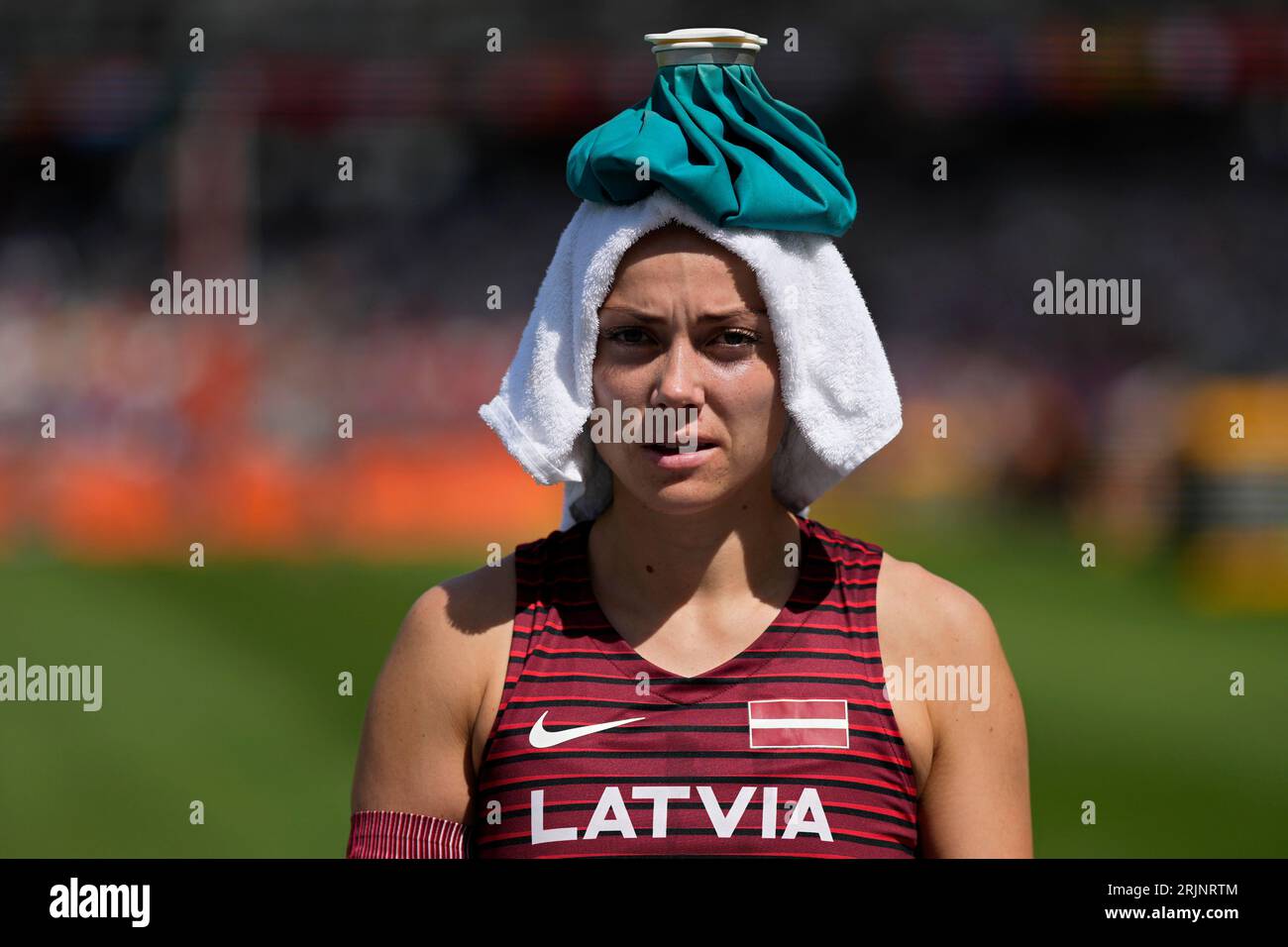 Anete Kociņa, of Latvia, uses an ice pack to lower her body temperature ...