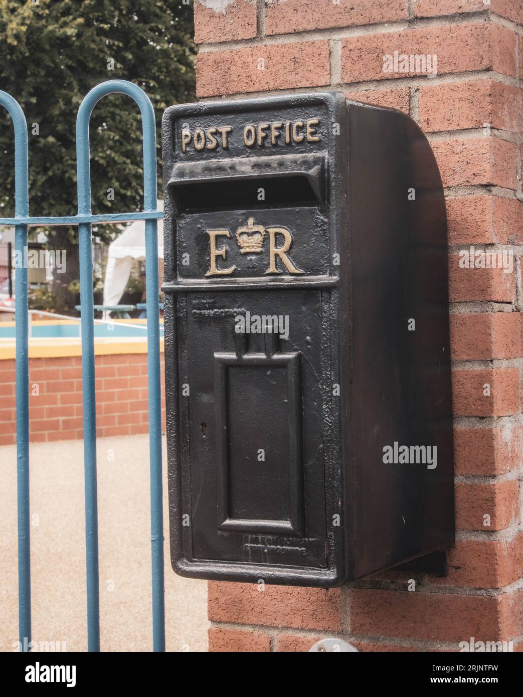 A vintage post box affixed to a rustic brick wall at the Lee Garden ...