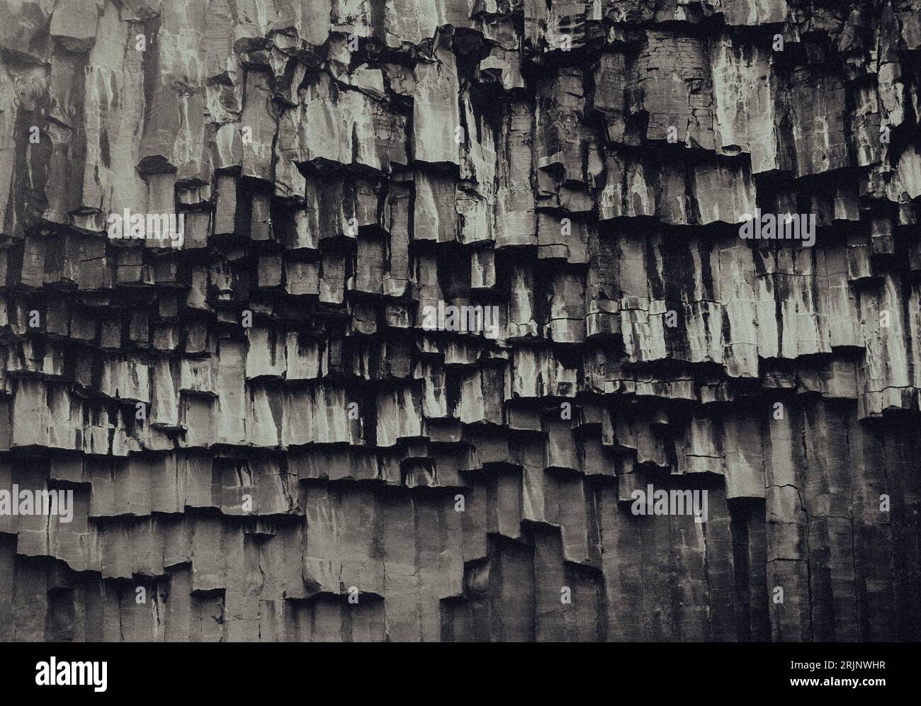 An aerial view of a rugged mountain range with jagged peaks and rocky ...
