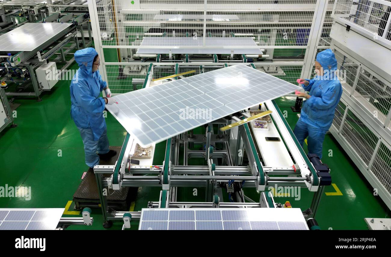NANTONG, CHINA - AUGUST 23, 2023 - Workers produce solar photovoltaic ...