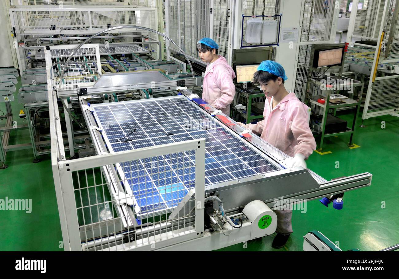 NANTONG, CHINA - AUGUST 23, 2023 - Workers produce solar photovoltaic ...