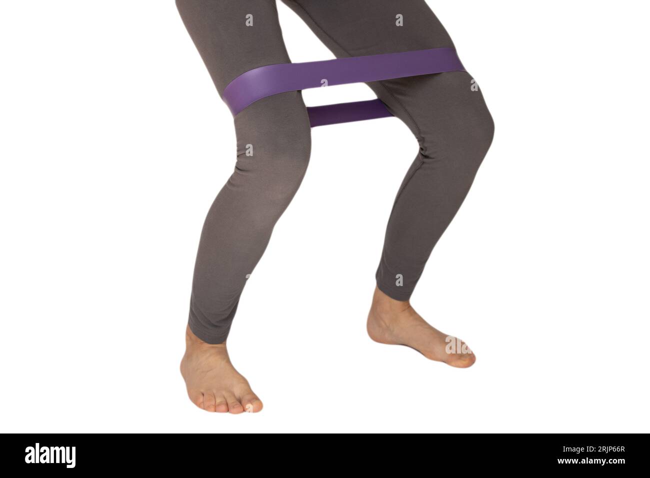 The girl is engaged in fitness with a fitness elastic band on a white ...