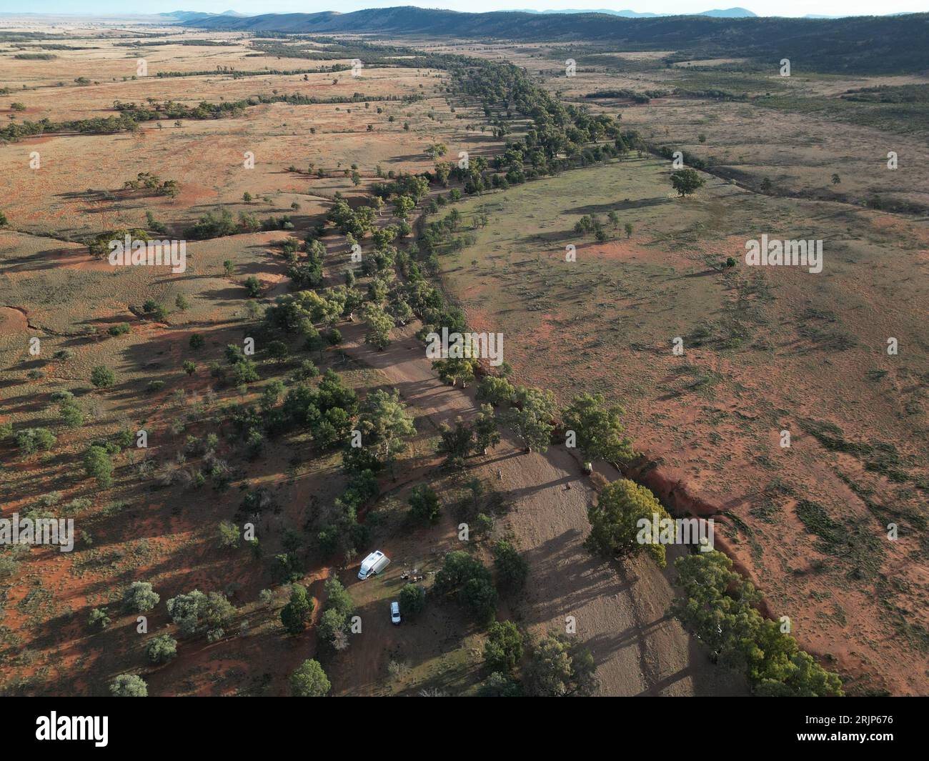 Aerial photograph of a vast open area featuring lush green trees and a ...
