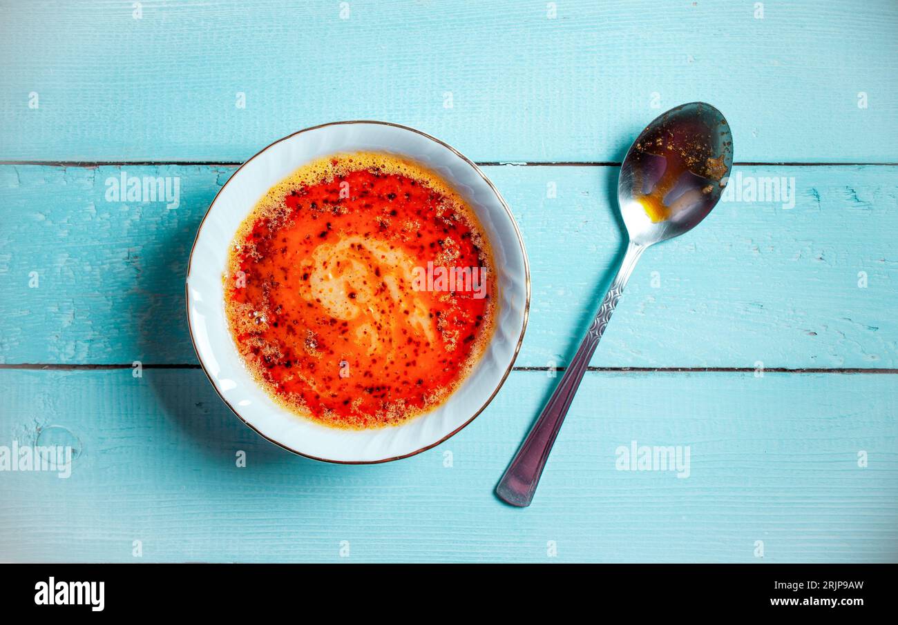 A top view of lentil soup with hot sauce (red chili pepper and butter ...