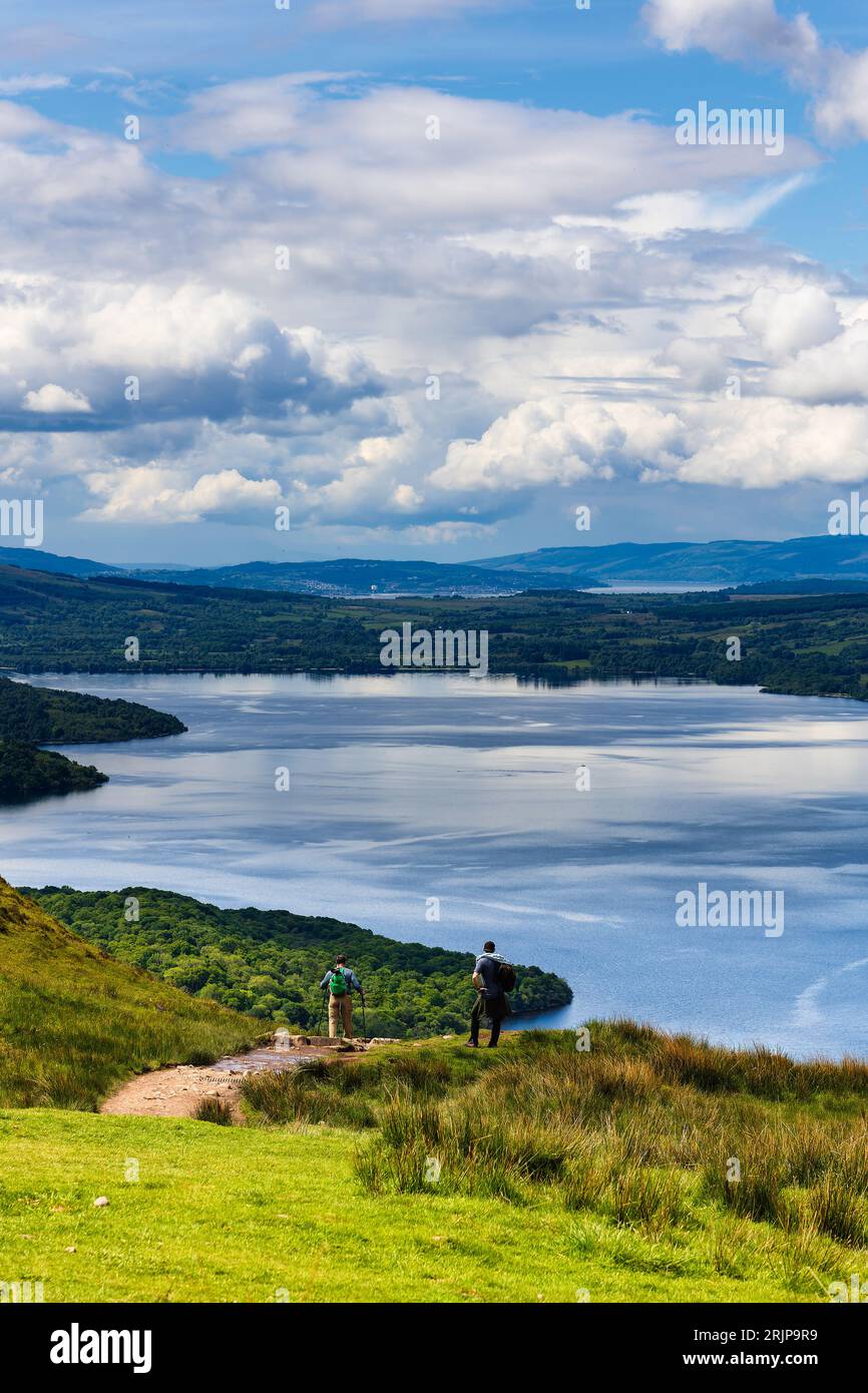 Hikers descending Conic Hill towards Loch Lomond with beautiful ...