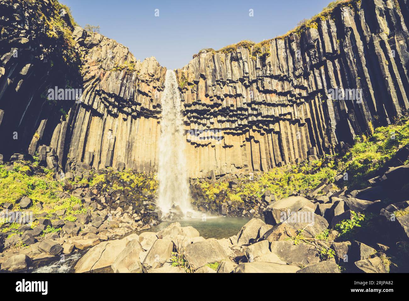 An expansive and majestic waterfall cascading down a rocky cliff face ...