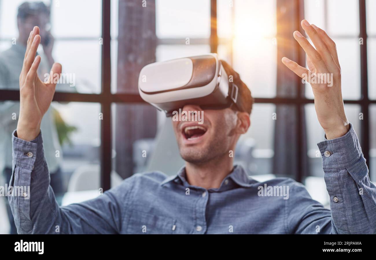 Cool handsome man put on virtual reality goggles for the first time in ...