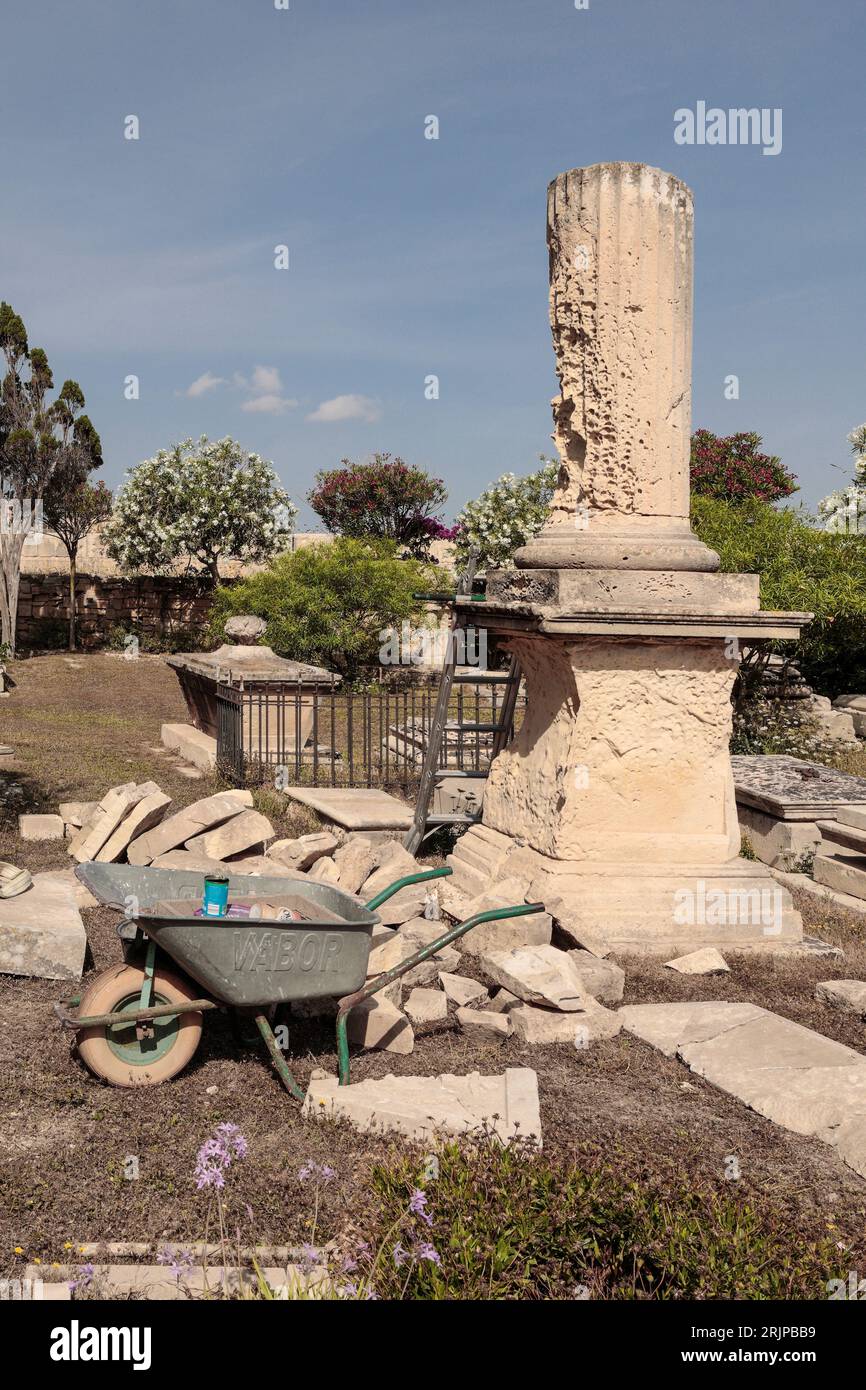 Wheelbarrow and other tools used in restoring funerary monuments at a ...