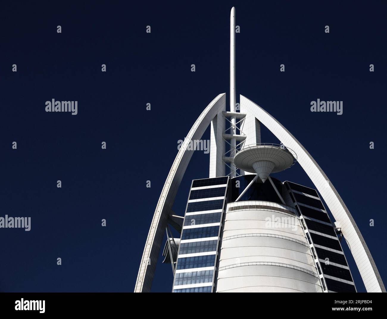 A tall tower is situated on the side of a contemporary urban building ...