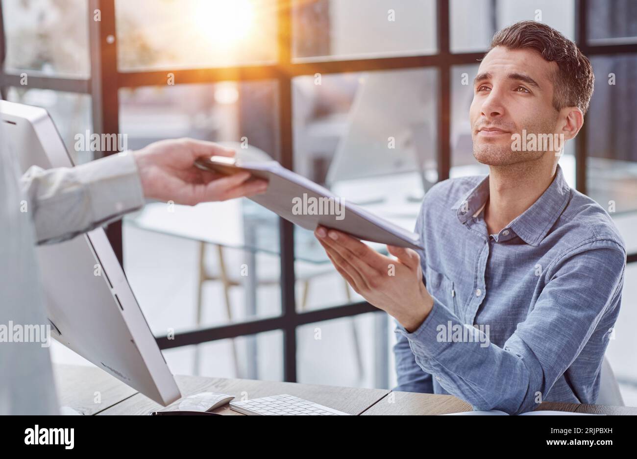 Focus on male hands passing each other folder with papers Stock Photo ...