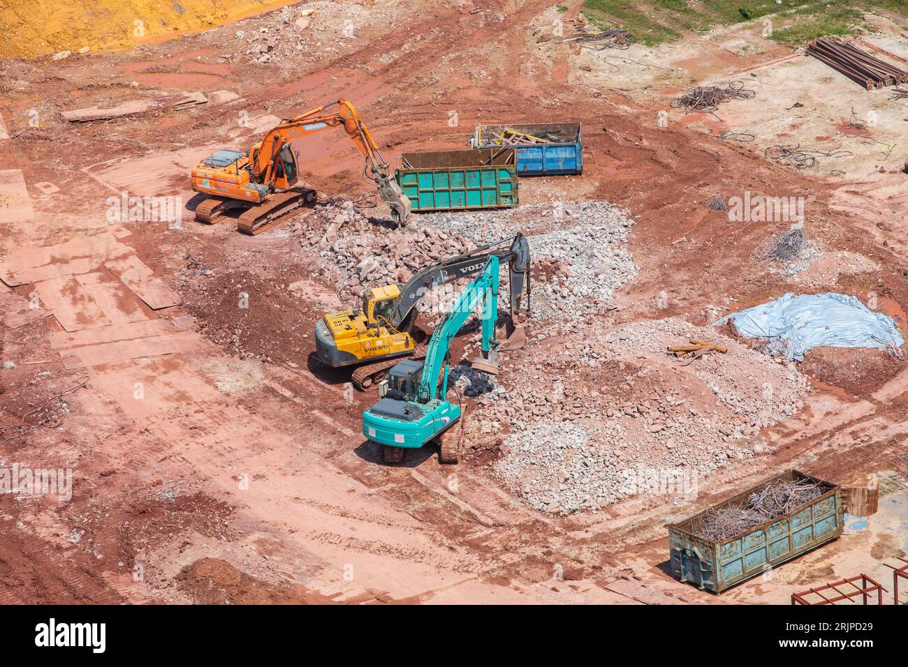Heavy industrial machinery is clearing the pile of debris during the ...