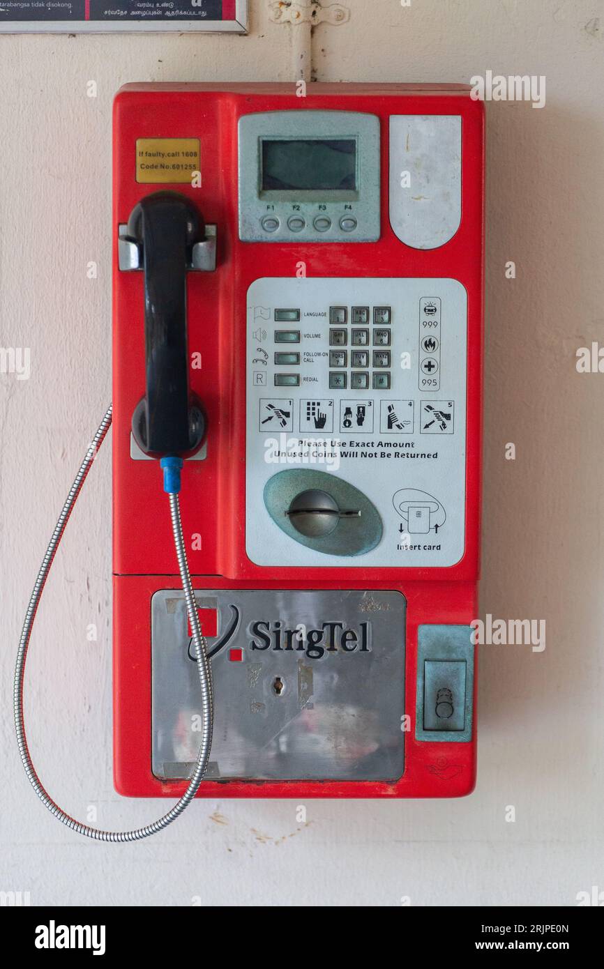 Vertical view. A rare sight of a red colour Singtel public pay phone ...