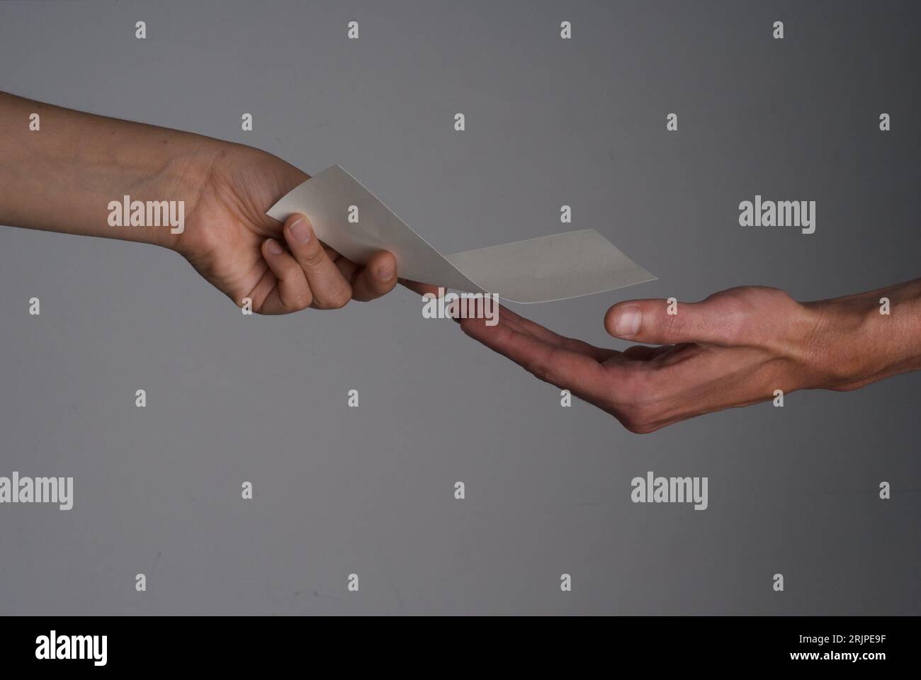 Photography of a hand giving a pice of paper to another hand Stock ...