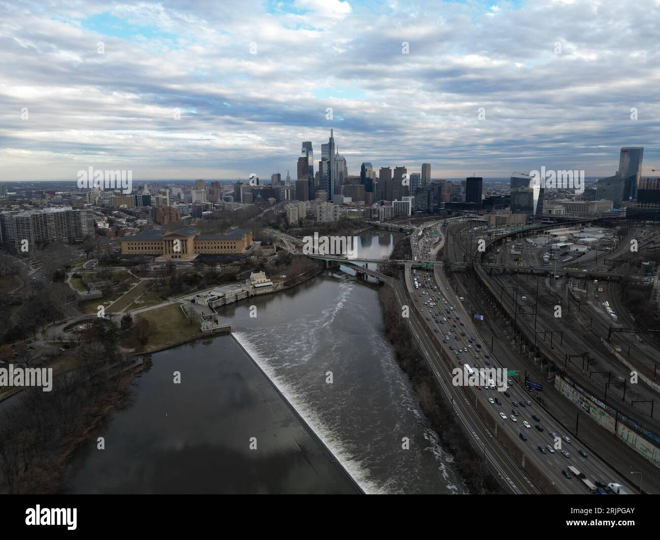 A scenic aerial view of a Philadelphia skylinewith a river flowing ...