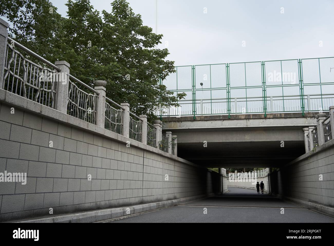 Somebodies walking through a concrete bridge Stock Photo - Alamy
