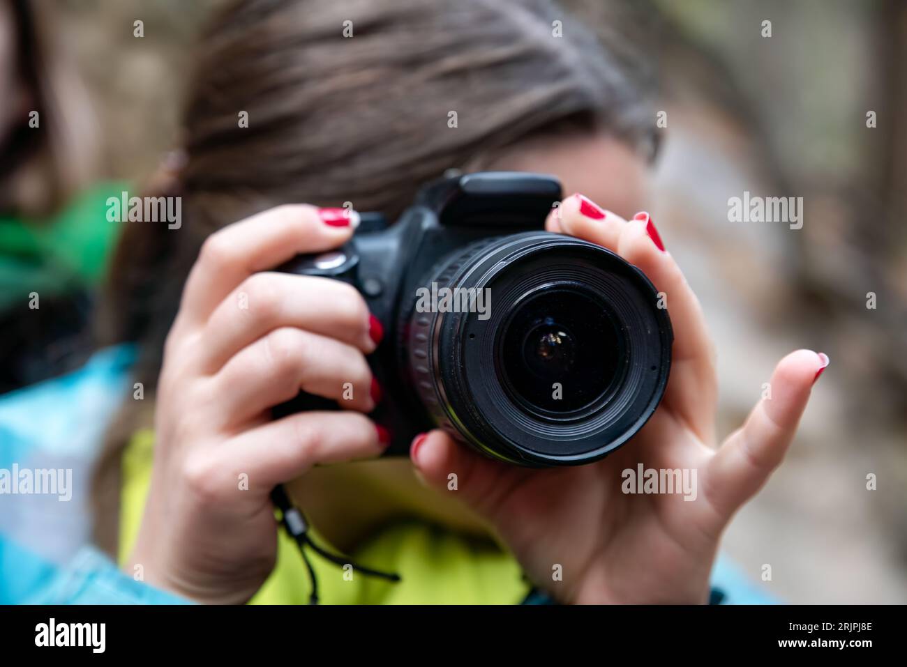 A closeup of a female photographer taking a picture Stock Photo - Alamy