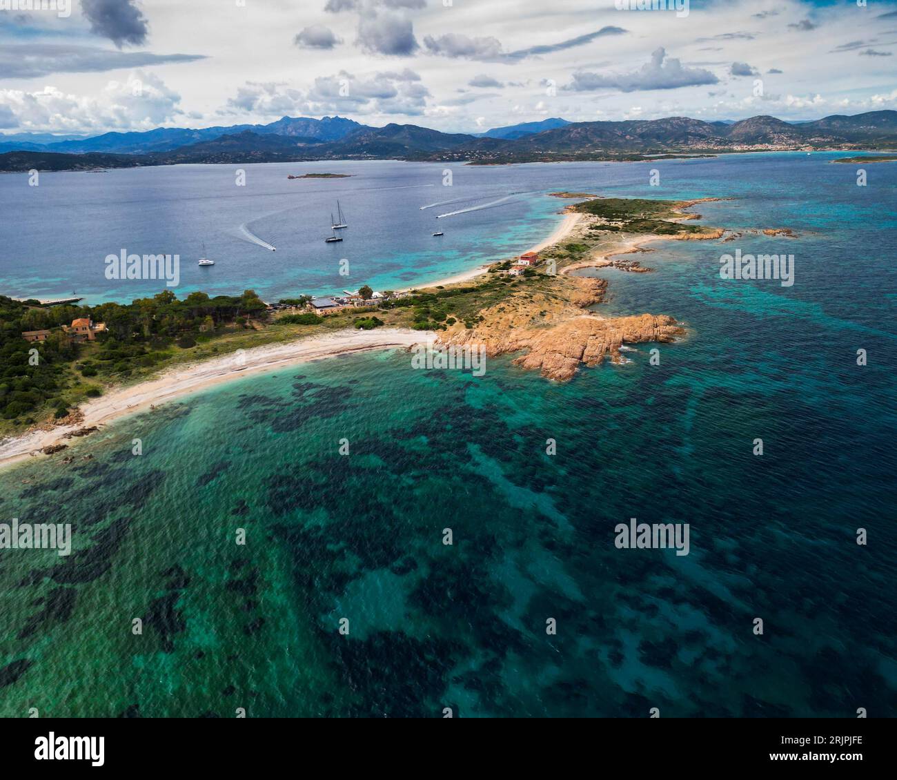 A stunning aerial view of a lush green forested island surrounded by an ...