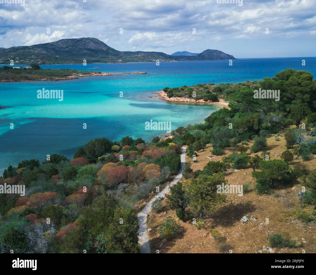 A stunning aerial view of a lush green forested island surrounded by an ...