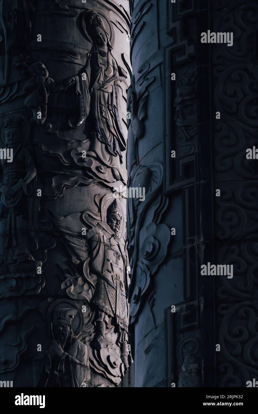 A vertical of black pillar with intricate carvings and designs Stock ...