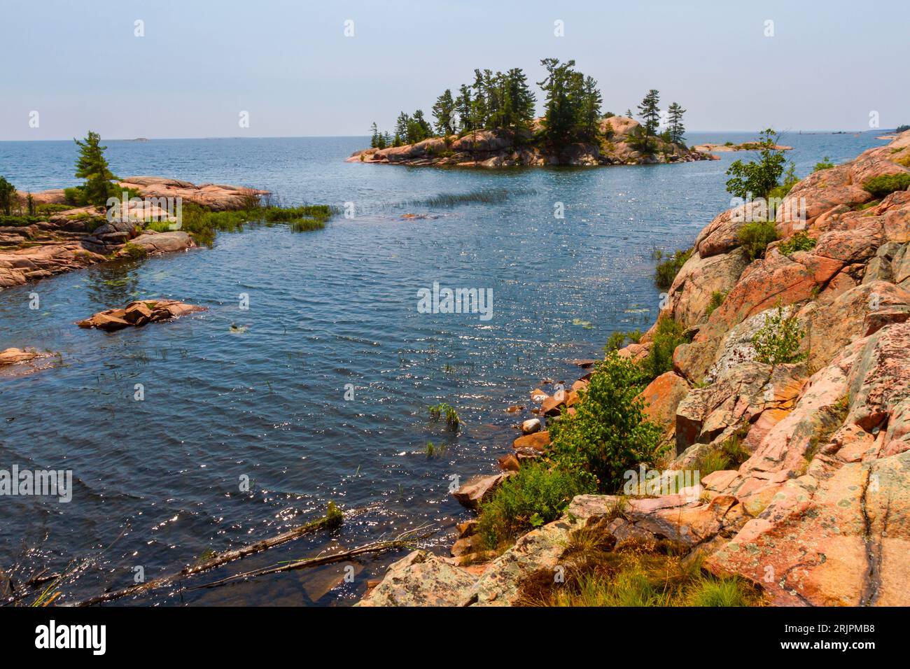 Shoreline along lake Huron. Granite Red rocks at the mouth of the ...