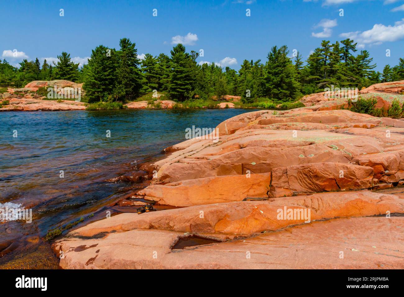 Shoreline along lake Huron. Granite Red rocks at the mouth of the ...