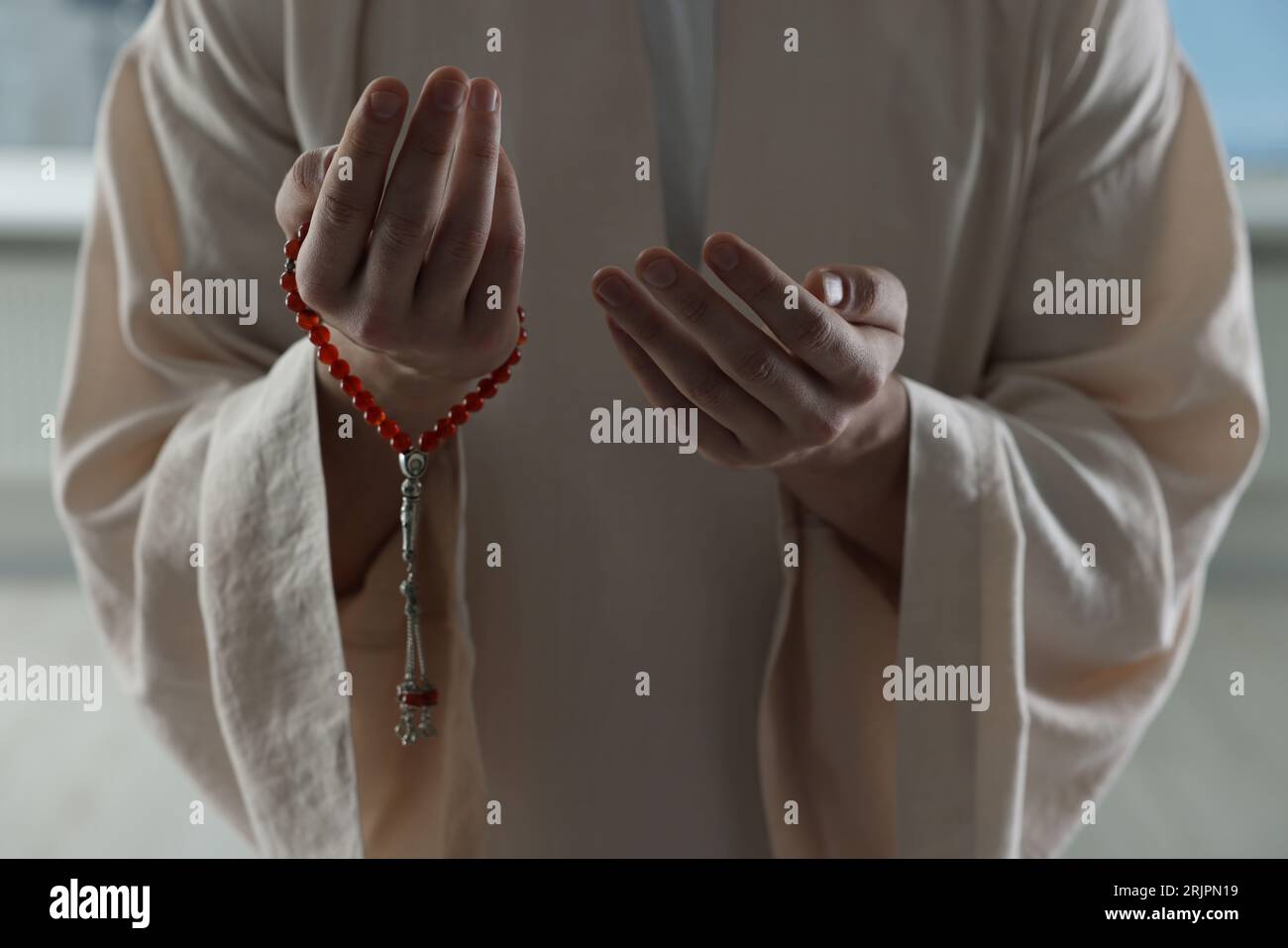 Muslim man with misbaha praying near window indoors, closeup Stock ...
