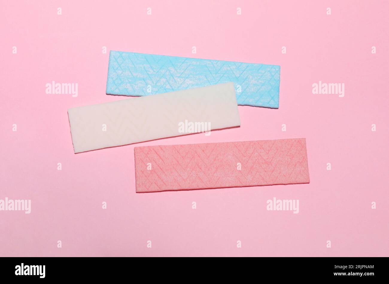 Sticks of tasty chewing gum on pink background, flat lay Stock Photo ...