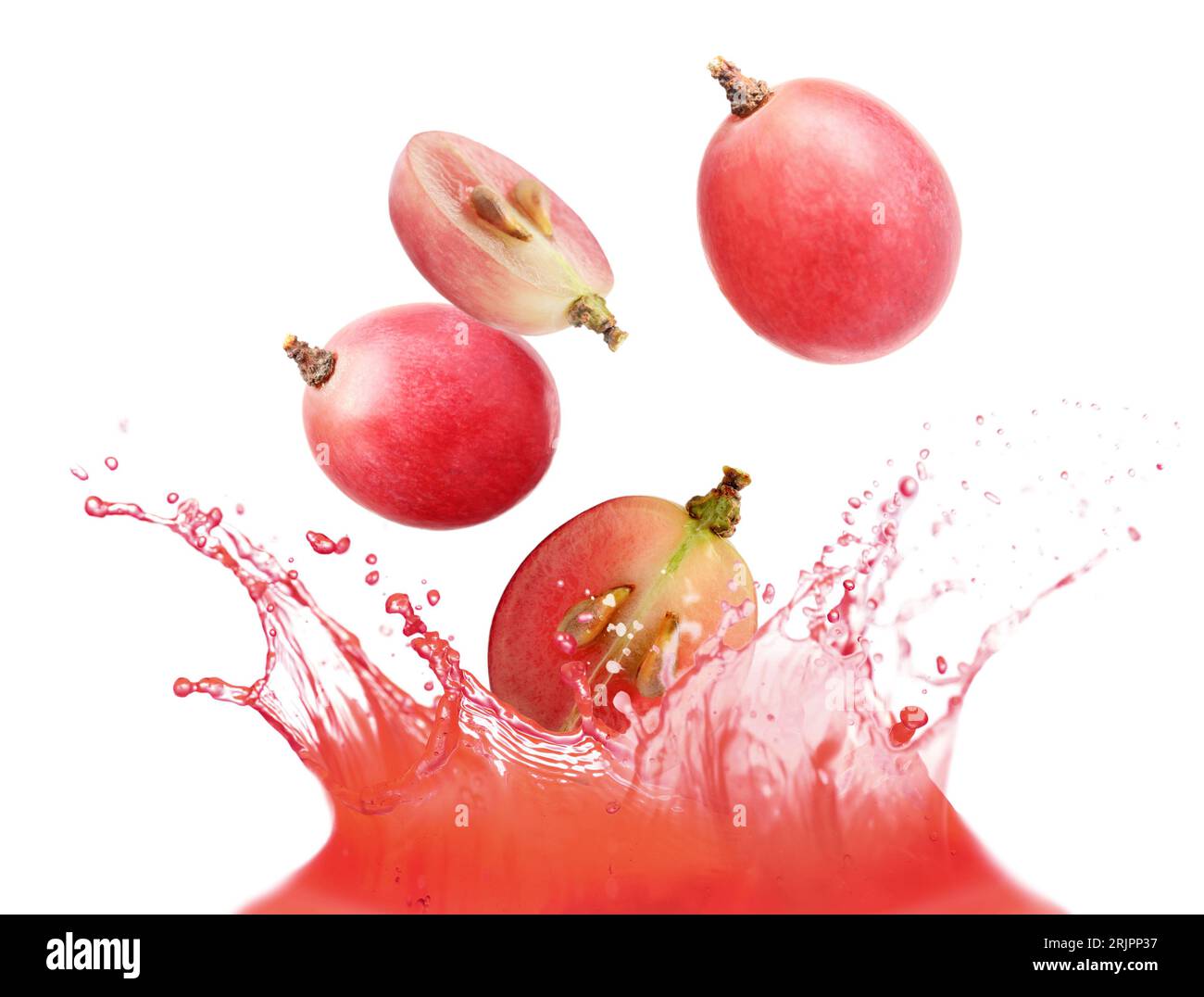 Grapes falling into juice on white background Stock Photo - Alamy