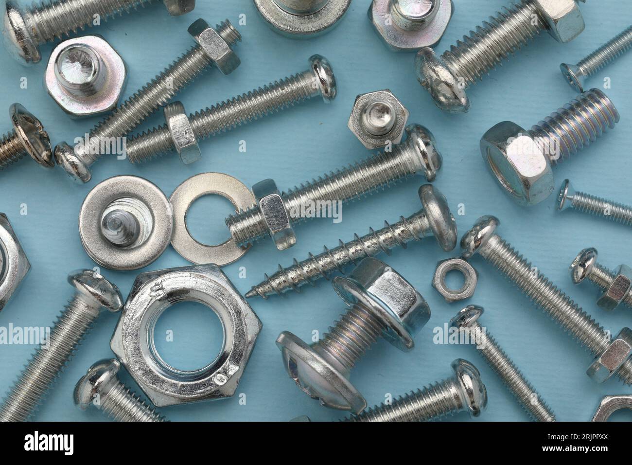 Many different fasteners on light blue background, flat lay Stock Photo ...