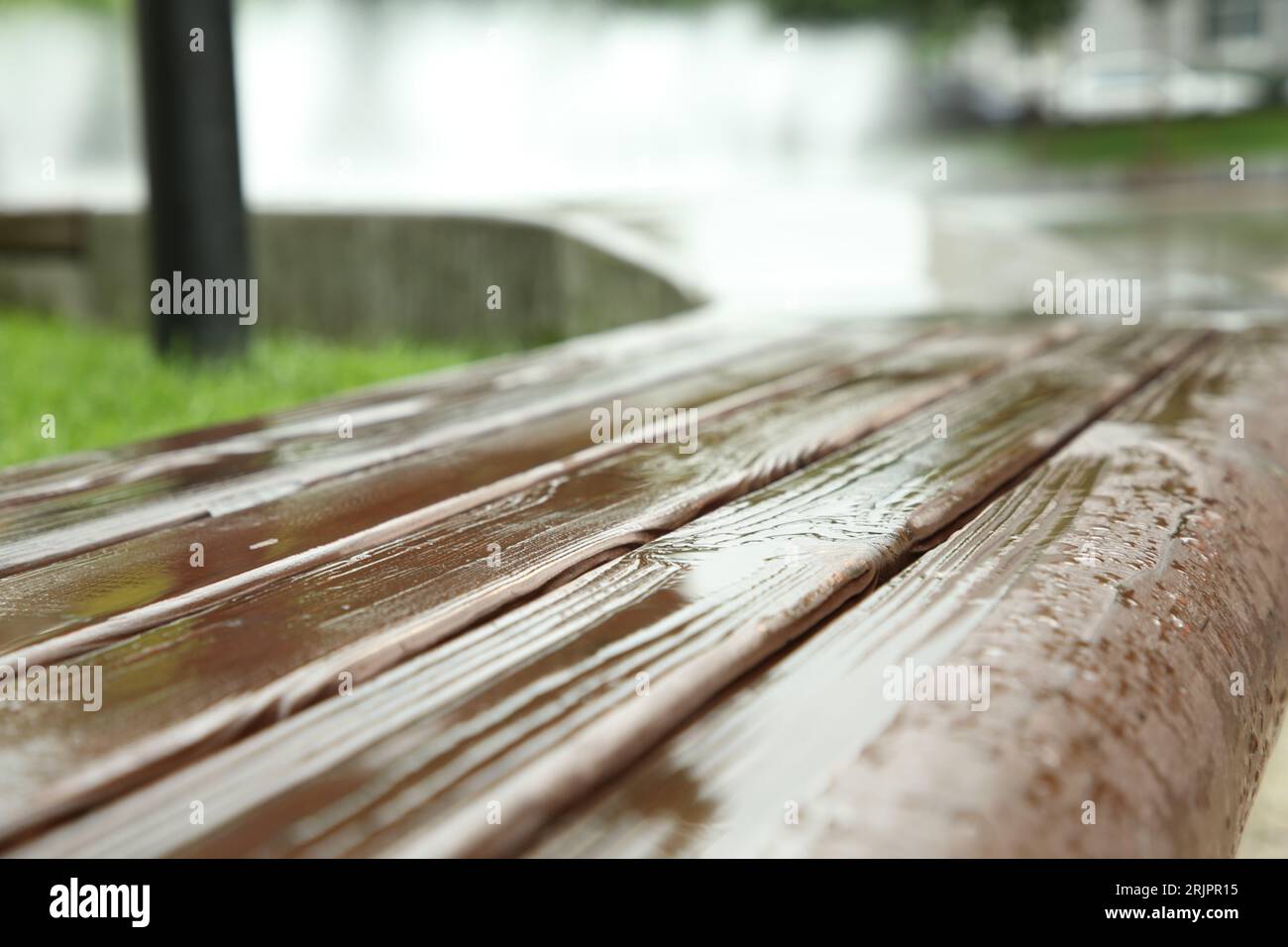Wooden bench with water drops outdoors, closeup. Rainy weather Stock ...