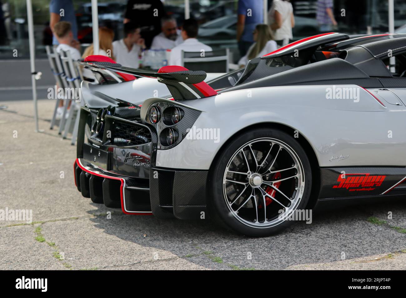 A glossy Pagani Huayra Roadster BC 1.20 parked on a paved surface with ...