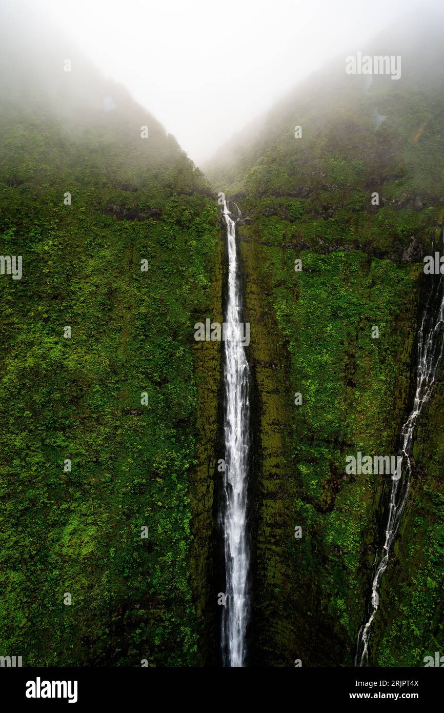 A breathtaking view of a waterfall cascading down a lush green ...