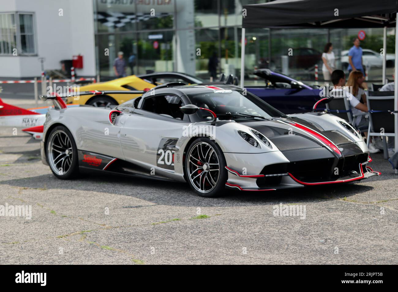 A glossy Pagani Huayra Roadster BC 1.20 parked on a paved surface with ...