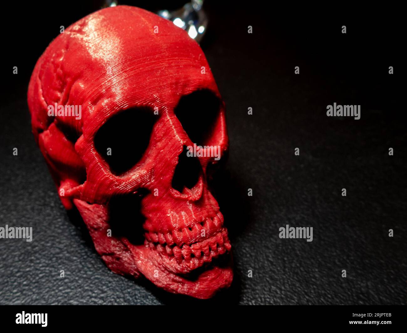 A vibrant red human skull on a striking black background Stock Photo ...