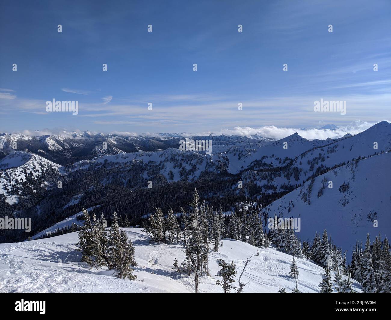 An idyllic winter scene of distant snow-capped mountains covered in a ...